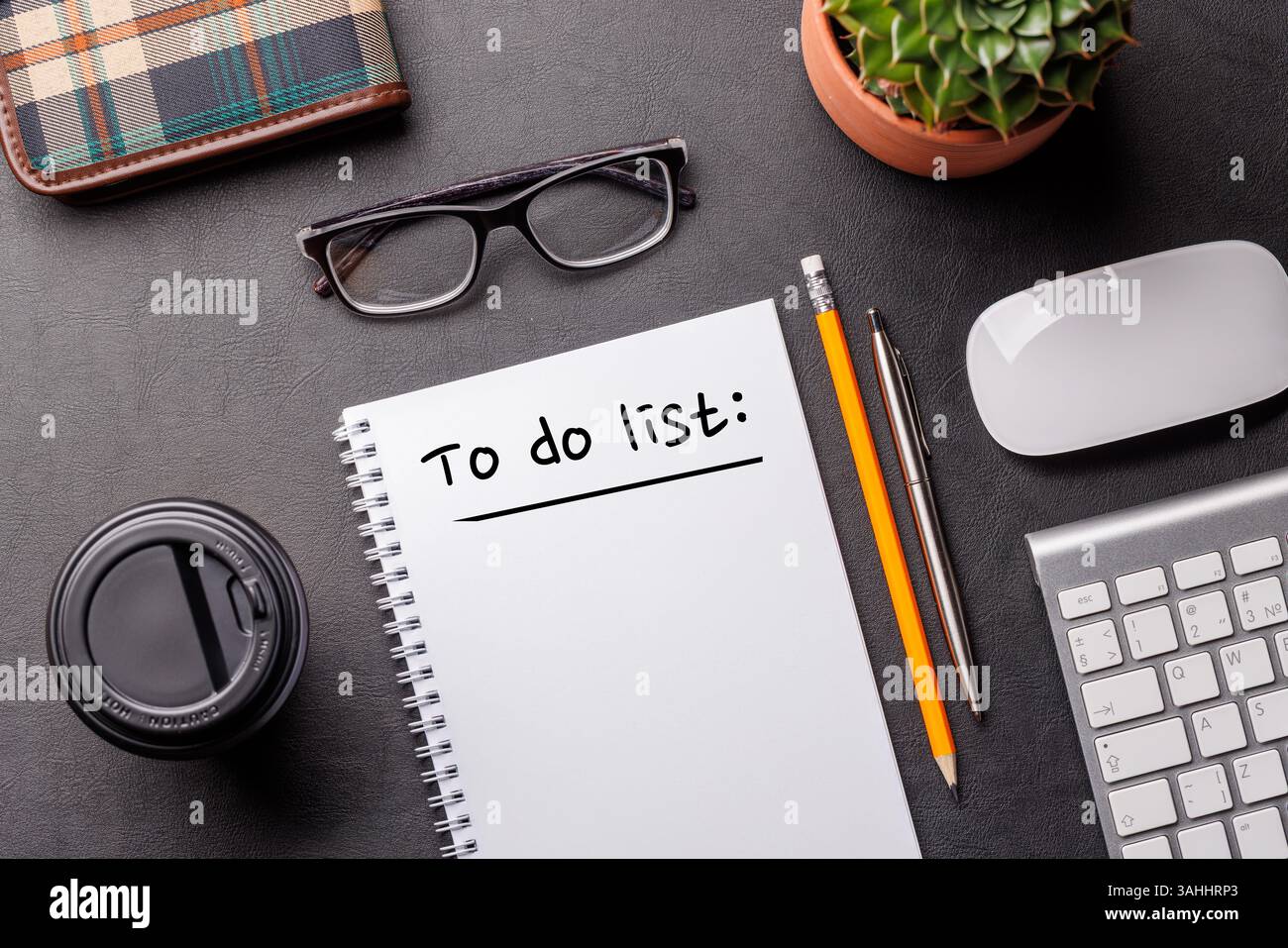 Organized work desk setup with PC, office supplies, coffee and a ...