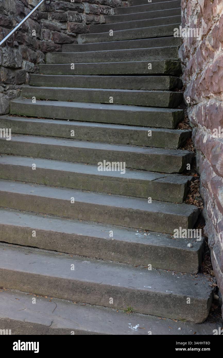 Sturdy stone steps ascend between rough-hewn walls, evoking a sense of ...