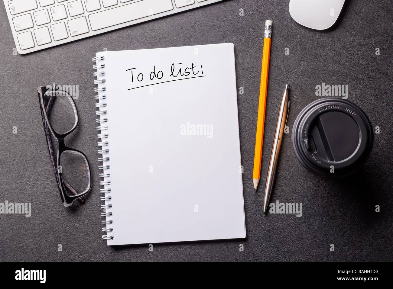 Organized work desk setup with PC, office supplies, coffee and a ...