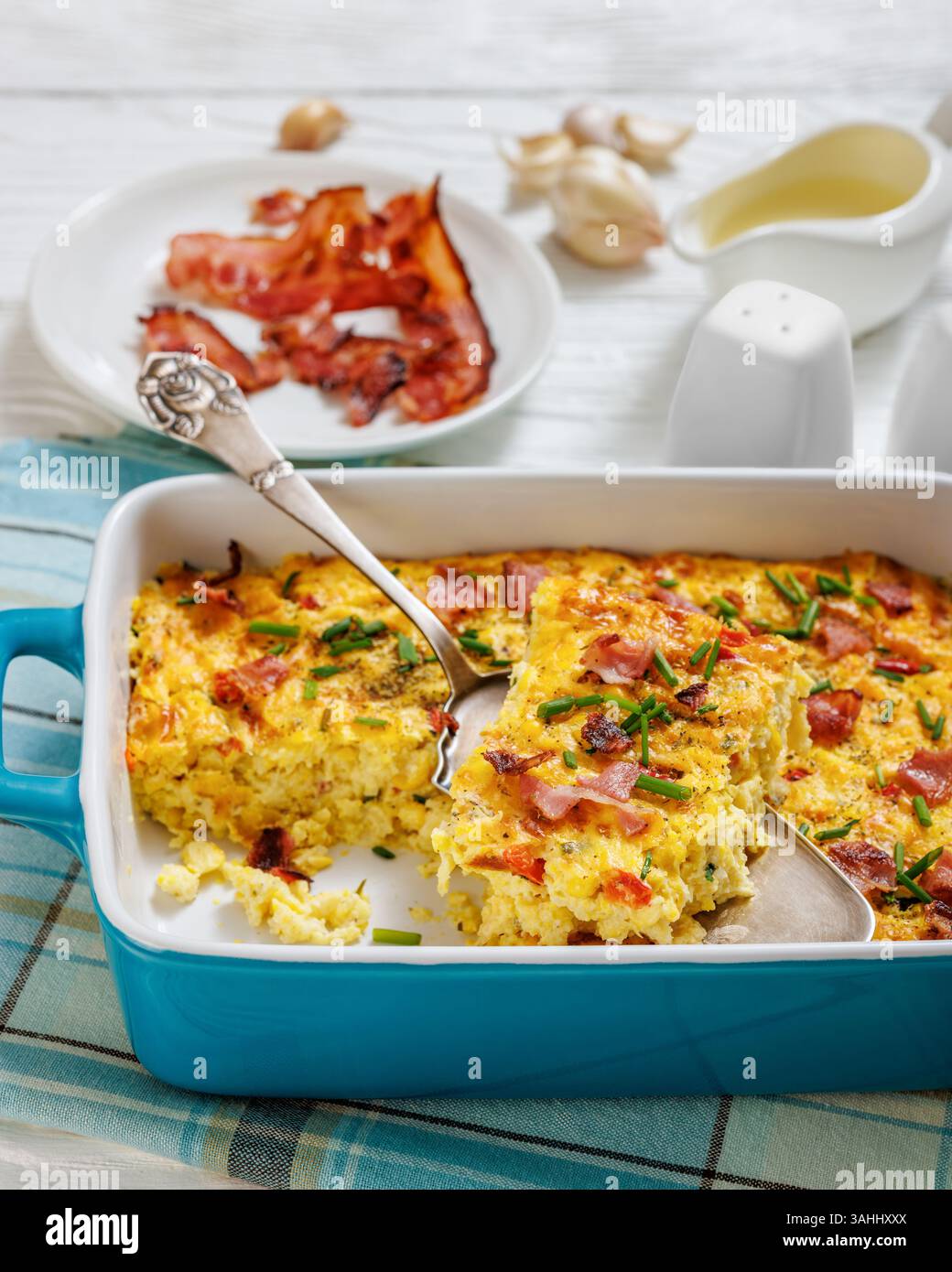 corn pudding casserole sprinkled with chives and crispy fried bacon in ...