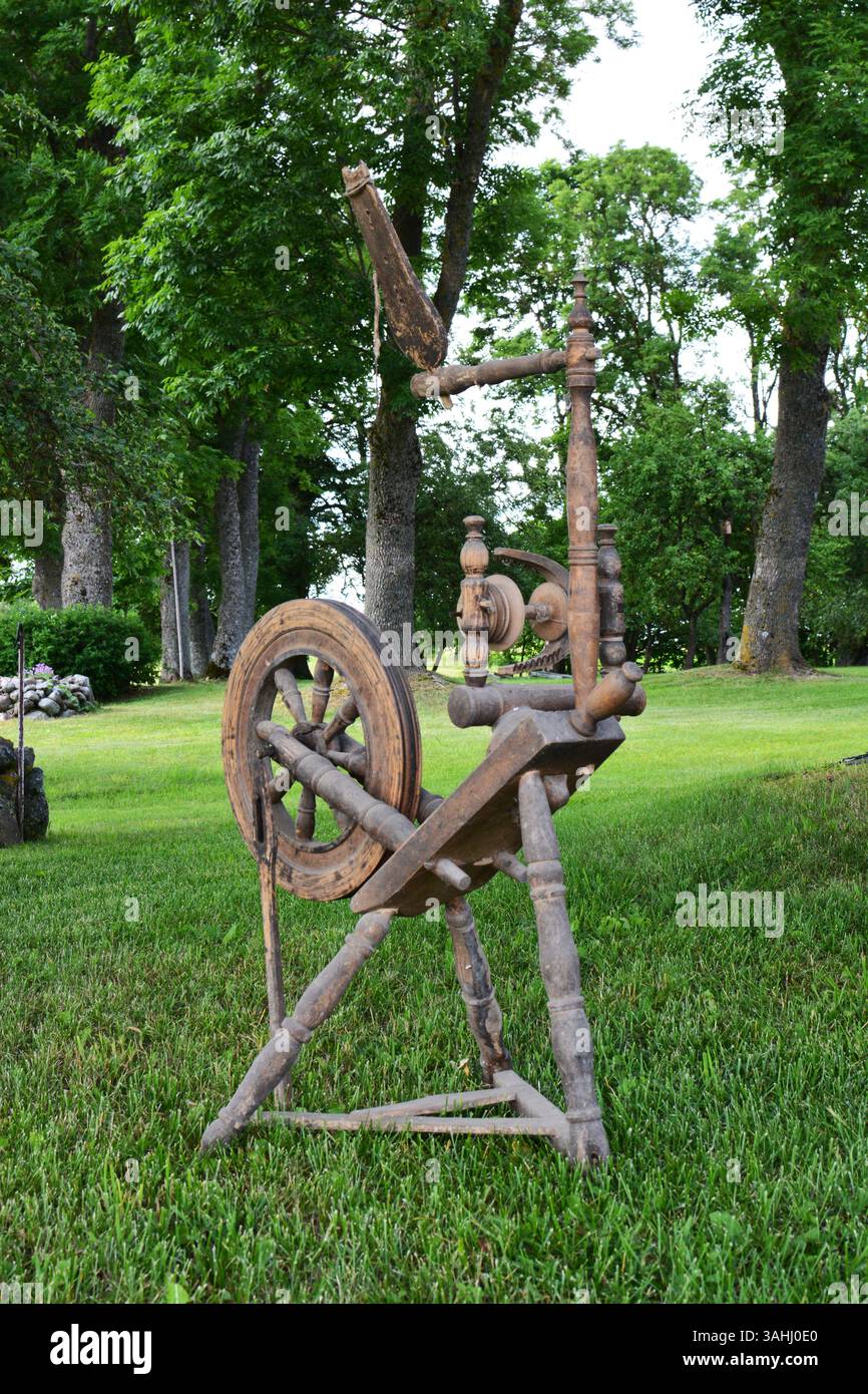 Authentic vintage wooden elm spinning wheel in countryside area for ...