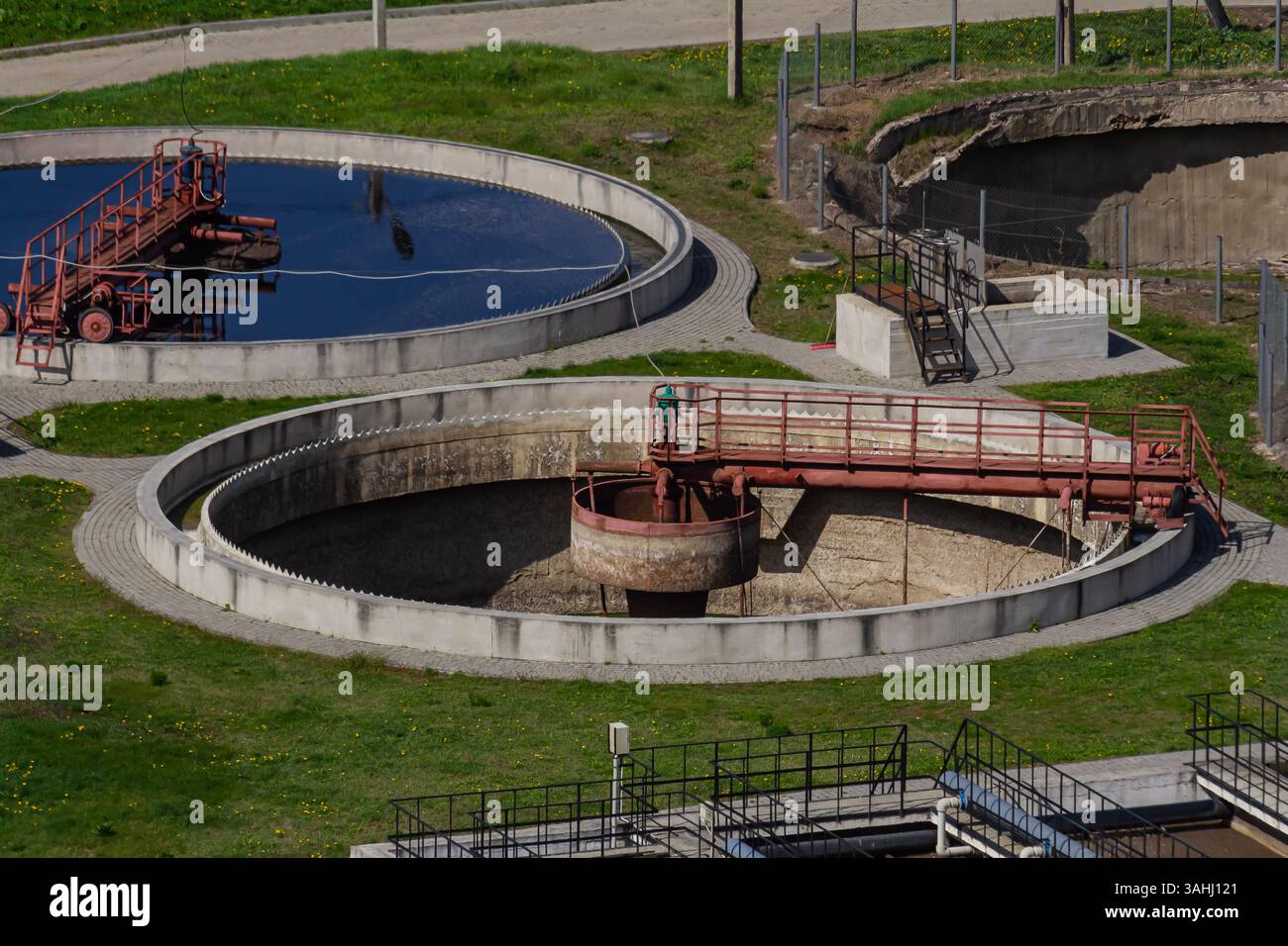 Circular wastewater treatment tanks are actively processing water at a ...