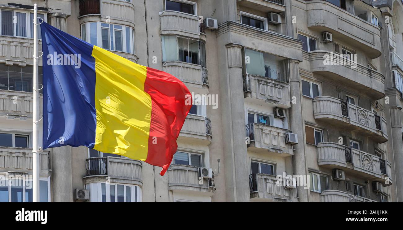 The vibrant colors of the Romanian flag stand out against a backdrop of ...