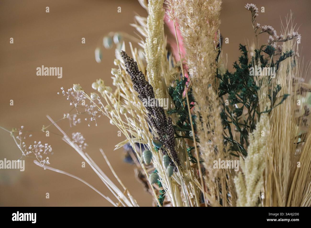 A beautiful dried flower arrangement showcases various grasses and ...