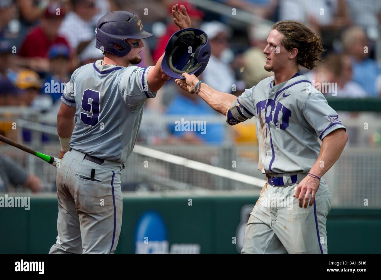 June 14, 2015: TCU Evan Skoug #9 and TCU Cody Jones #1 celebrate a run ...