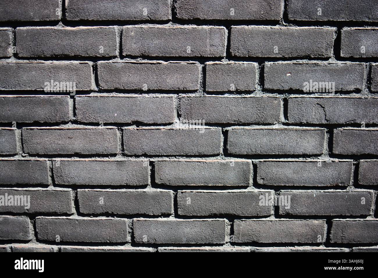 Wall background of dark grey bricks.Grey brick wall background. Dark ...