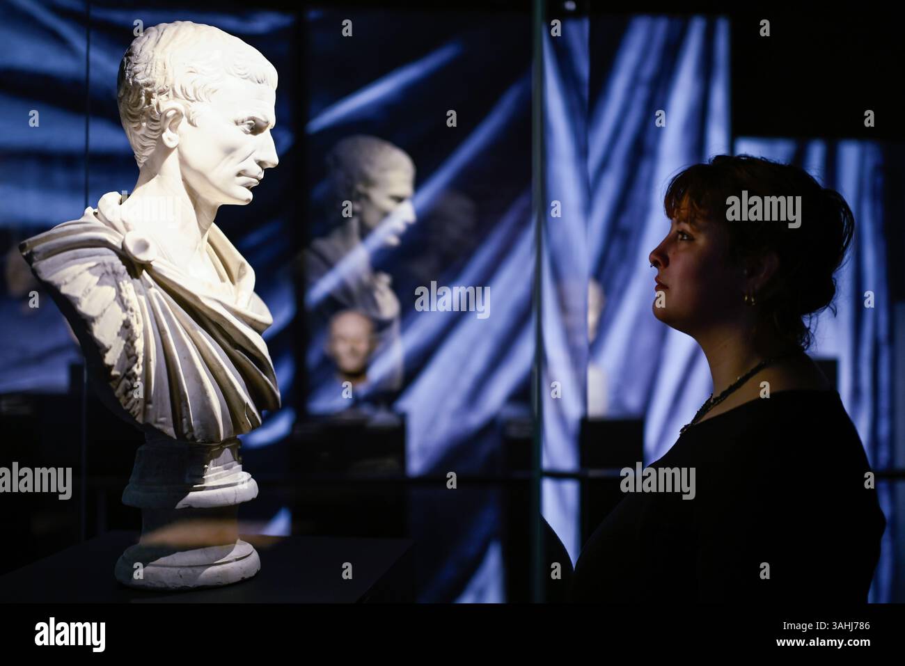 Speyer, Germany. 10th Apr, 2025. A woman stands in front of a bust of ...