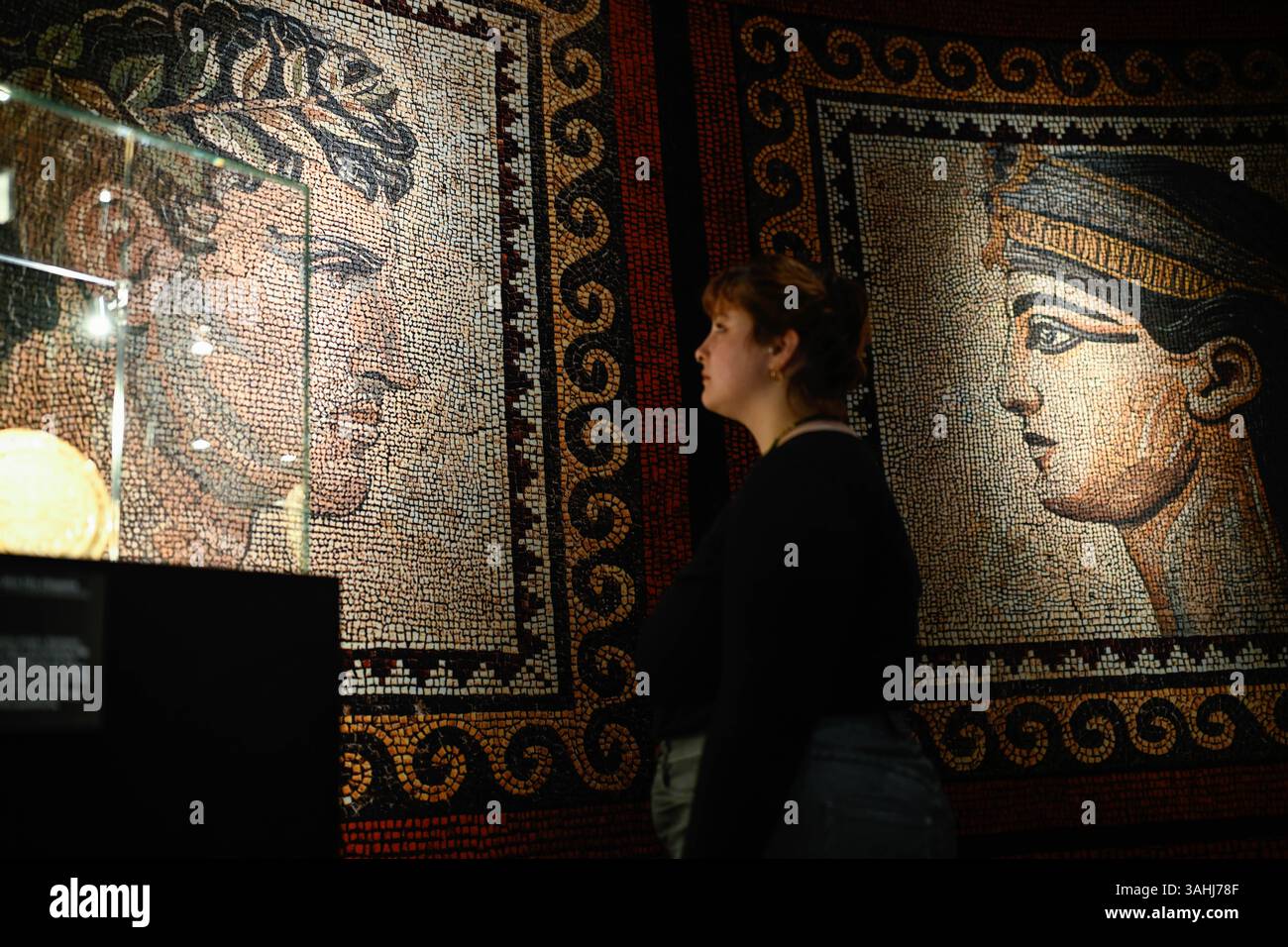 Speyer, Germany. 10th Apr, 2025. A woman stands in front of a tapestry ...