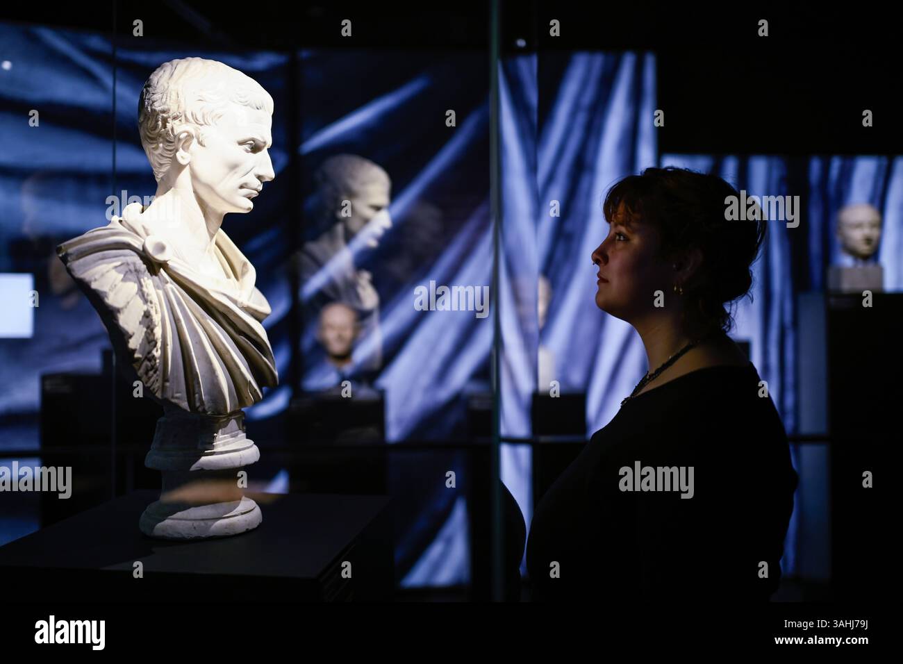 Speyer, Germany. 10th Apr, 2025. A woman stands in front of a bust of ...