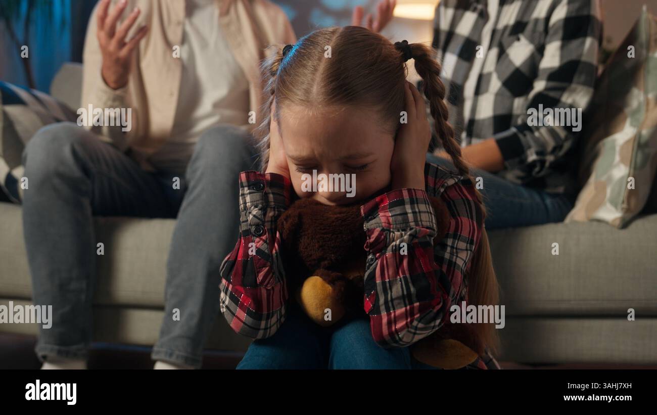Sad child girl kid daughter upset suffering hugging toy Teddy bear ...