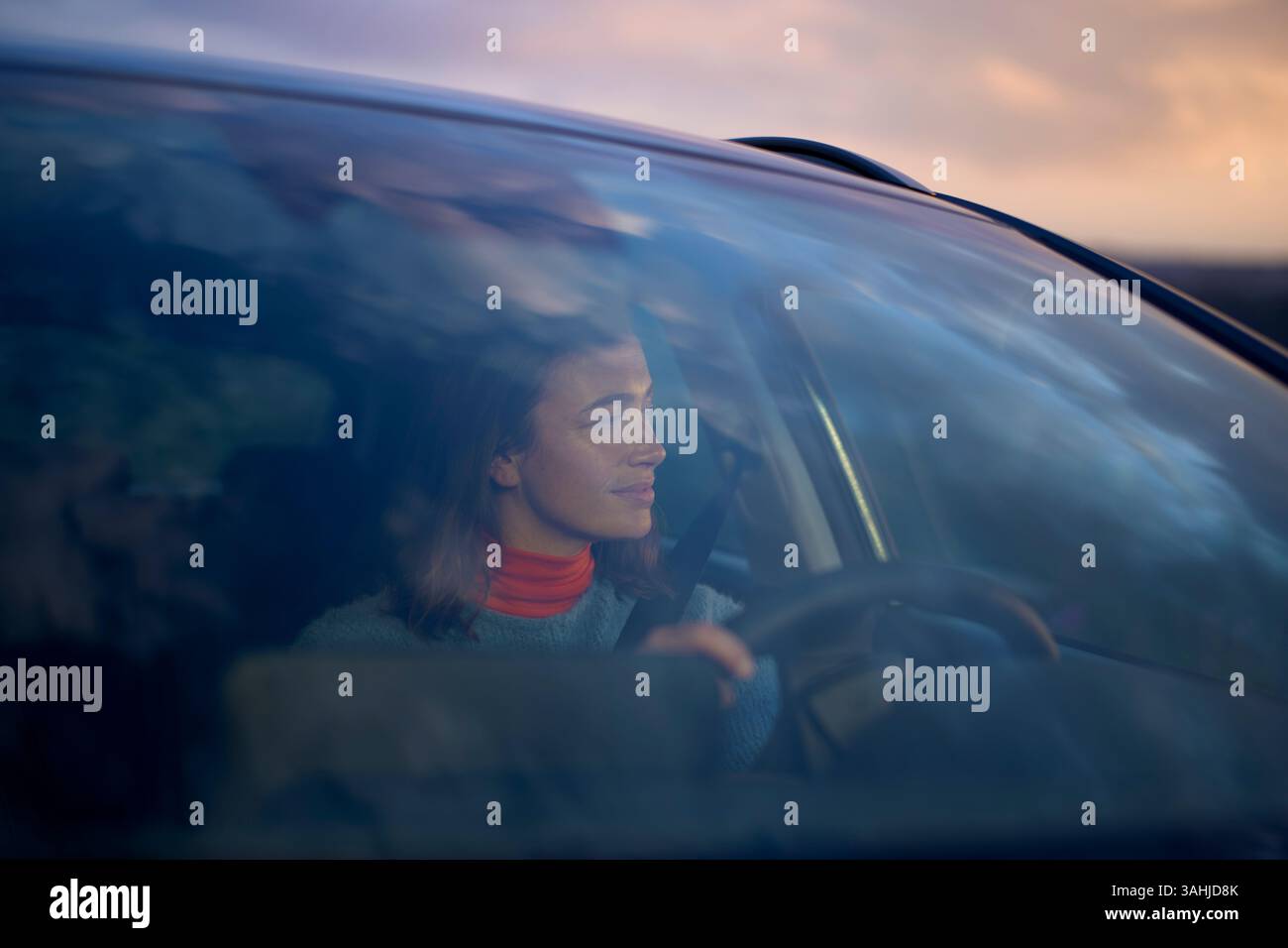 Woman driving seen through windshield of car hi-res stock photography ...