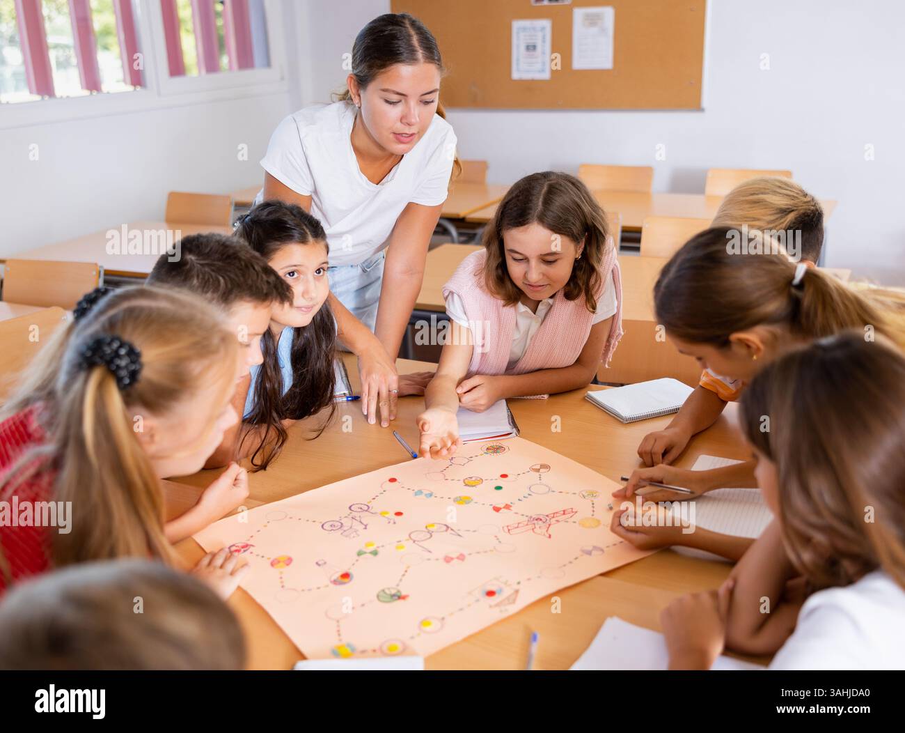 Teacher and schoolchildren play table game in school class Stock Photo ...
