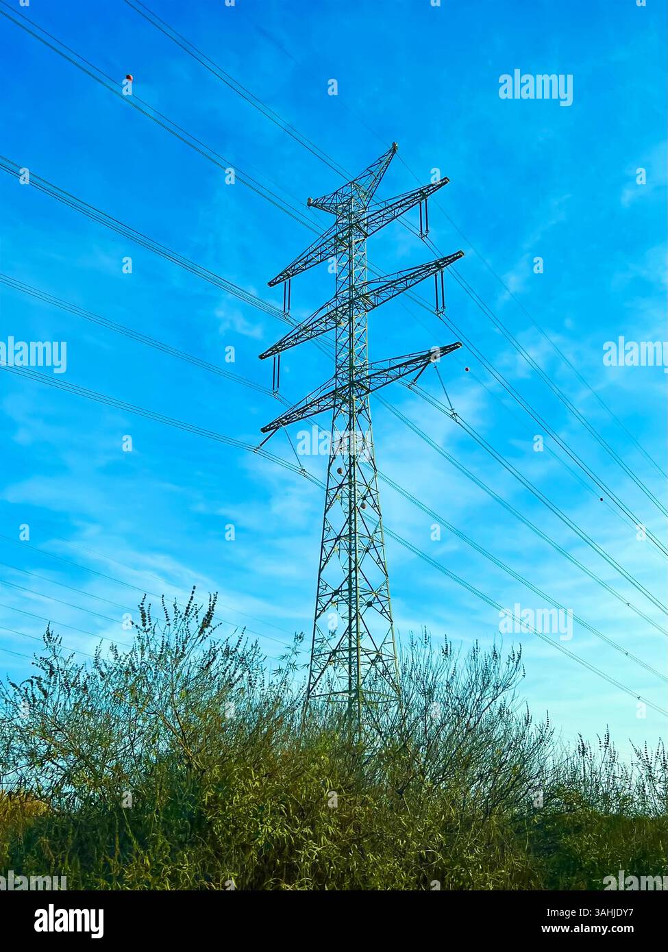 High voltage power line against the blue sky. Metal wires on a high ...
