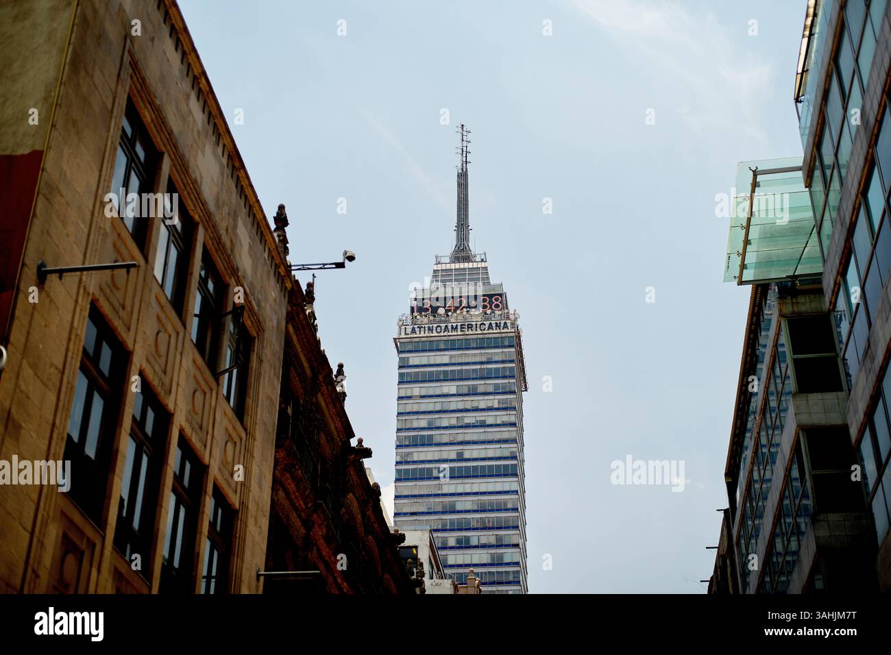 Torre Latinoamericana rises between historic and modern buildings under ...