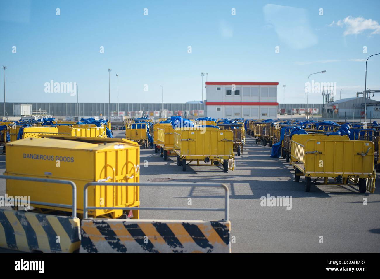 Yellow carts labeled dangerous goods at an industrial area with a ...