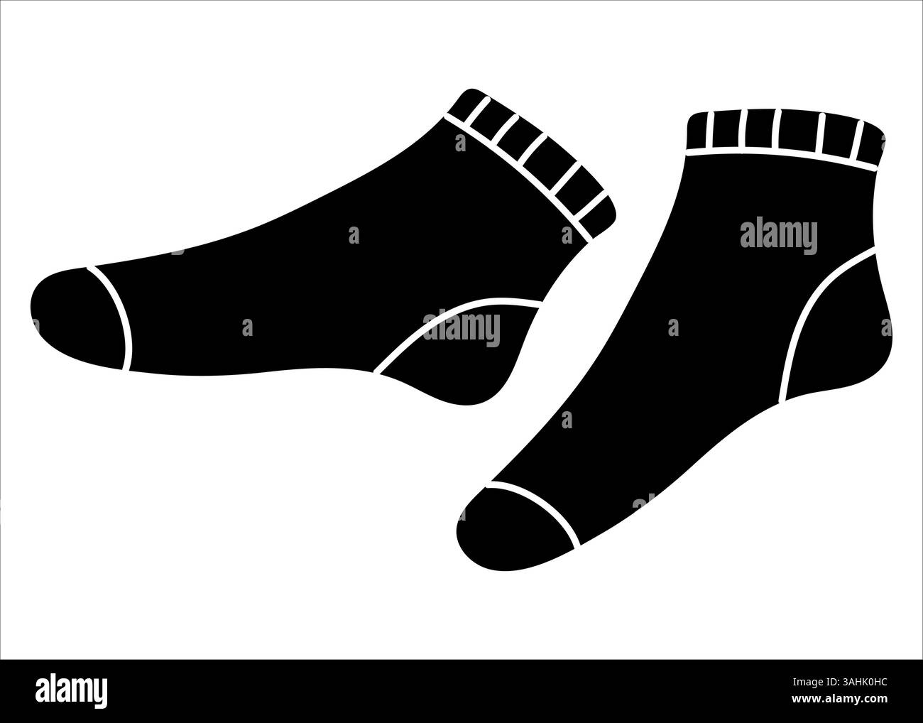 Two black socks with white detailing laid out on a plain background ...
