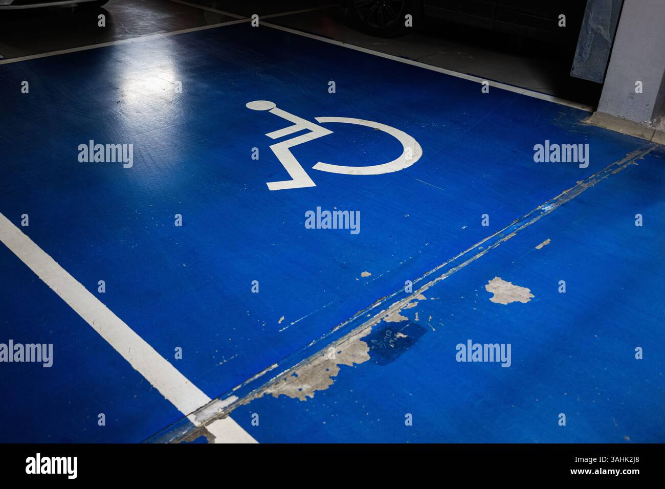 Marked blue handicap parking space with accessibility logo inside a ...