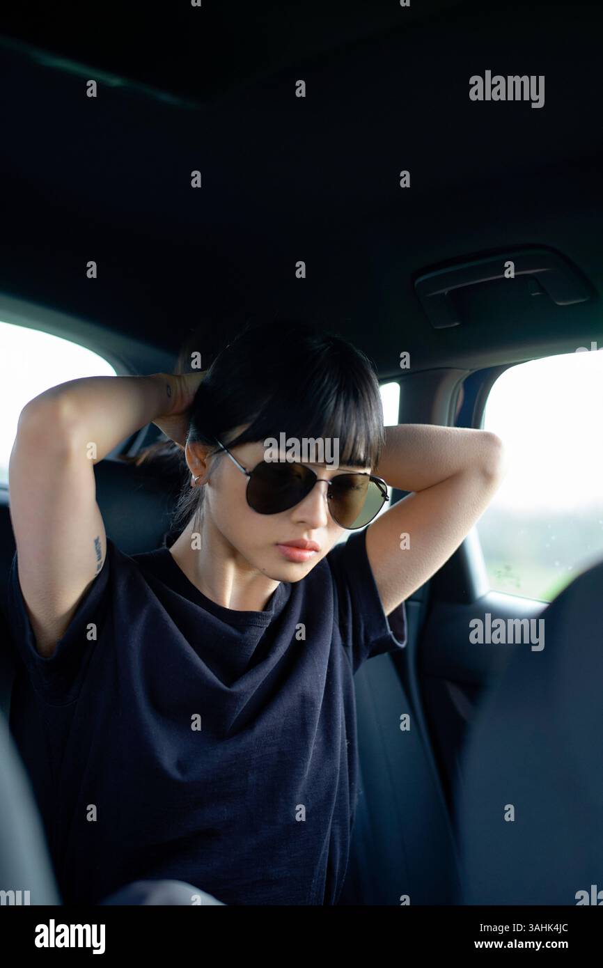 Young asian woman adjusts black hi-res stock photography and images - Alamy