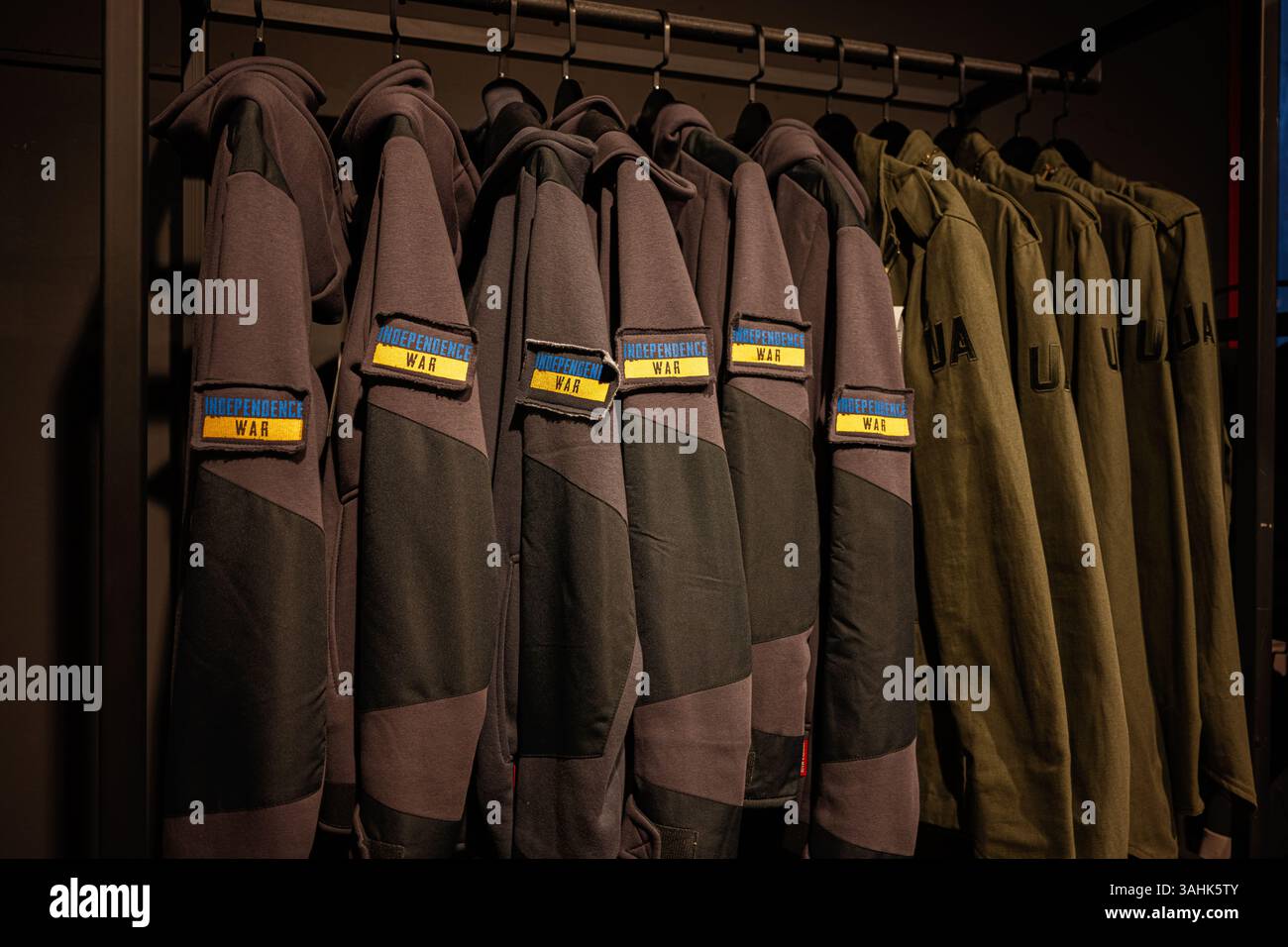 Several military-style uniforms displayed in rows, showcasing ...