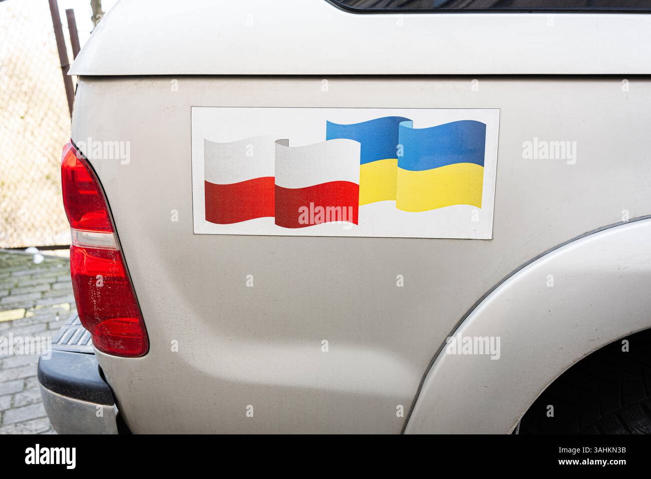 Car with Polish and Ukrainian flag stickers promoting unity and ...