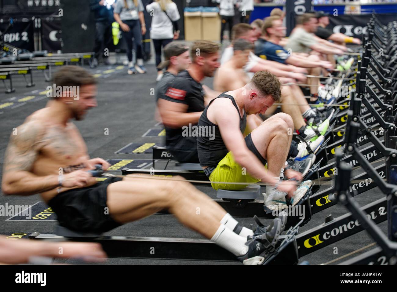 Cologne, Germany. 10th Apr, 2025. Participants row on rowing machines ...