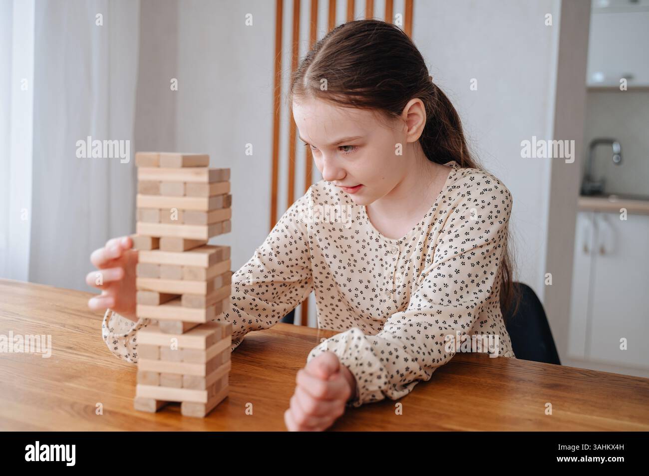 children playing educational board game at home in kitchen, girl ...