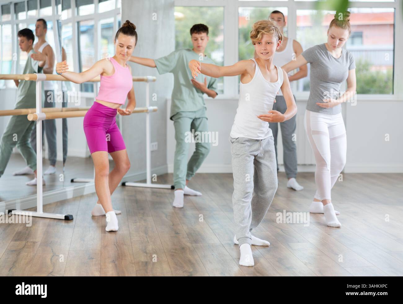 Girls and boys are learning various dance and ballet movements in ...