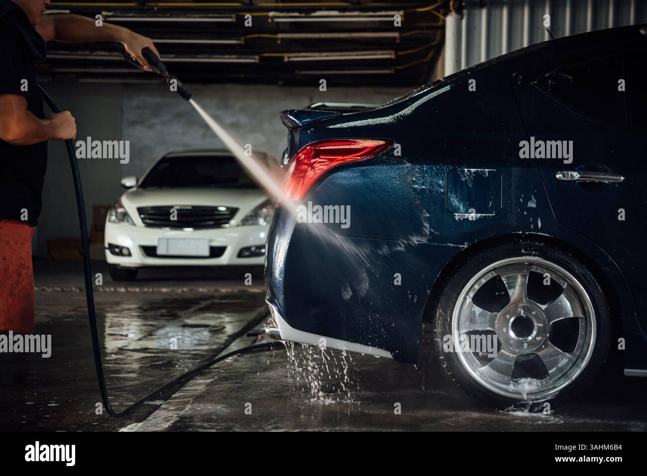 Car care staff cleaning (clean, wash, polish and wax) the car (Car ...