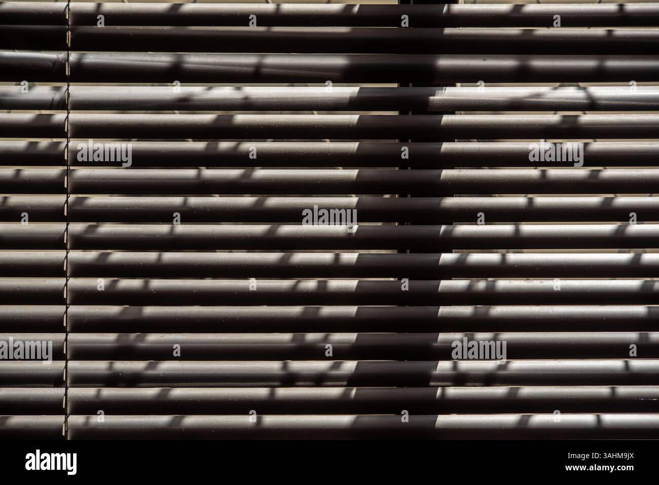 shutters (blinds) with the sun hitting them from behind and the outline ...