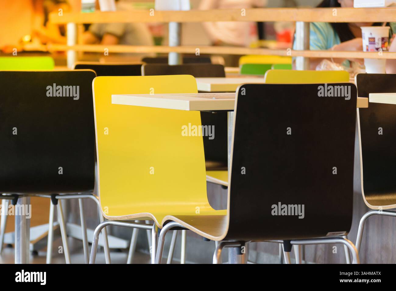Interior of the restaurant fastfood with bright colored chairs and ...