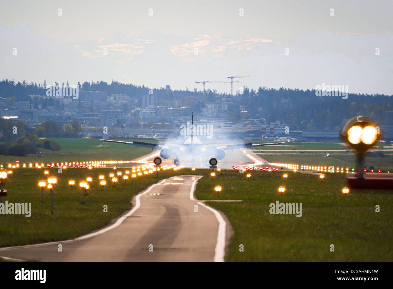 Commercial airplane seen from behind just before touching down and ...