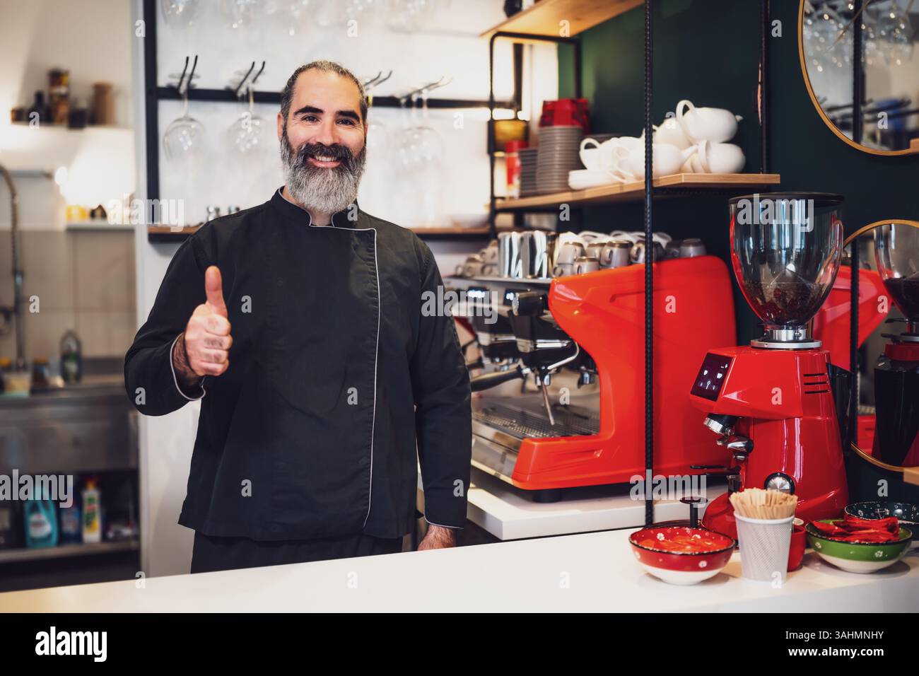 Professional barista in black apron working in restaurant. Portrait of ...