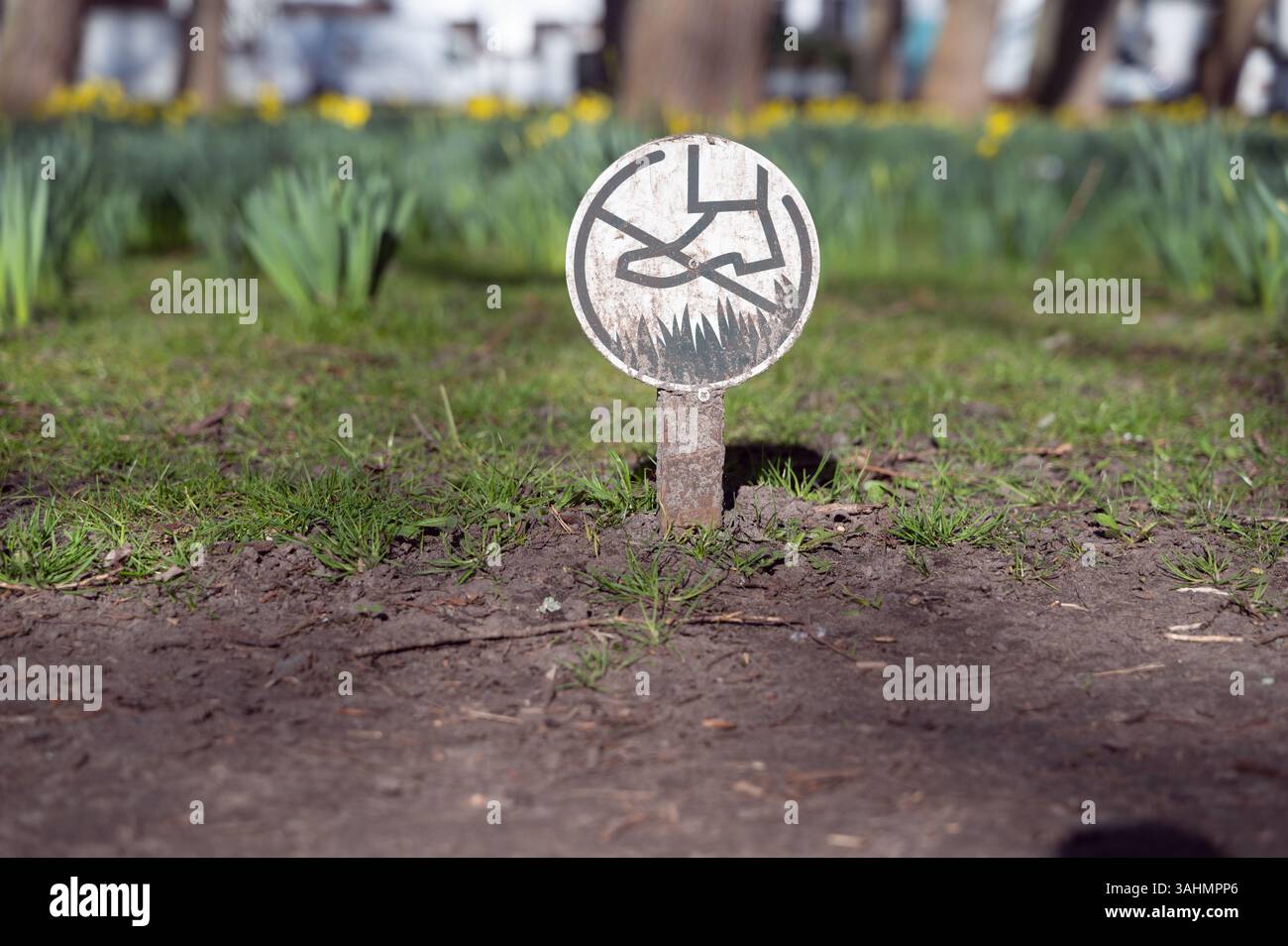 There is a noticeable sign placed in the grass that clearly states no ...