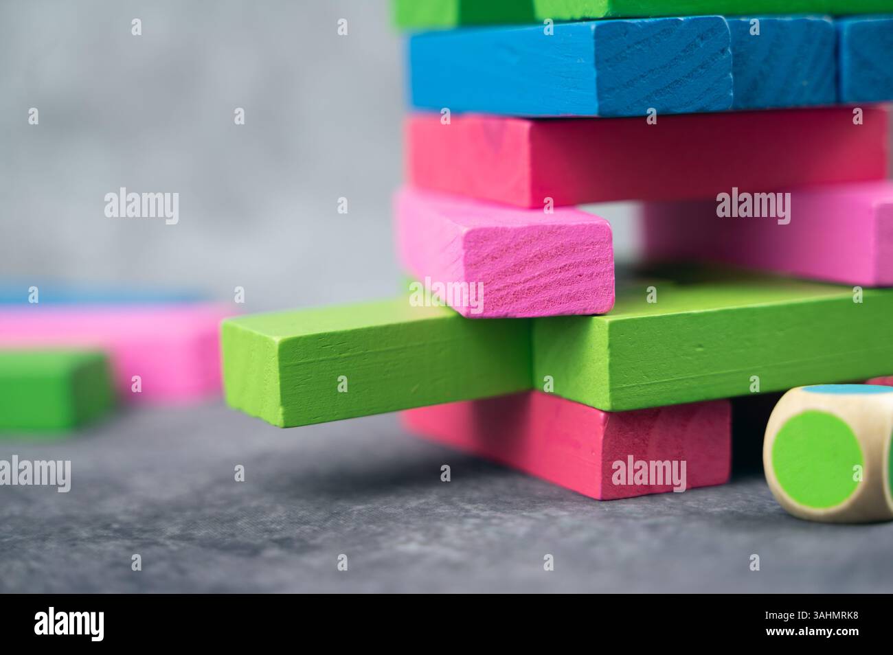 A colorful stack of wooden blocks in pink, blue, and green, perfect for ...