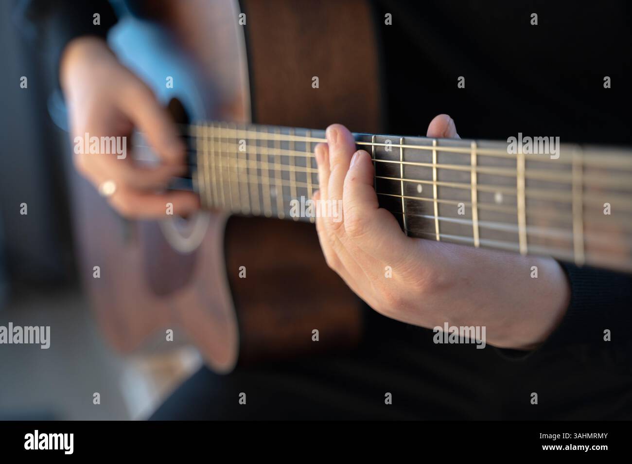 A closeup view of hands passionately and skillfully strumming an ...