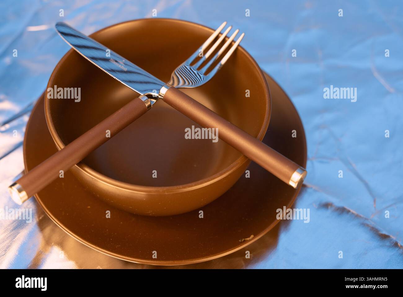 A tasteful arrangement of elegant dinnerware includes a bowl, plate ...