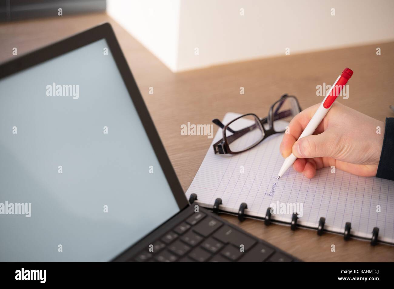 A serene workspace with a laptop, notepad, and glasses, perfect for ...