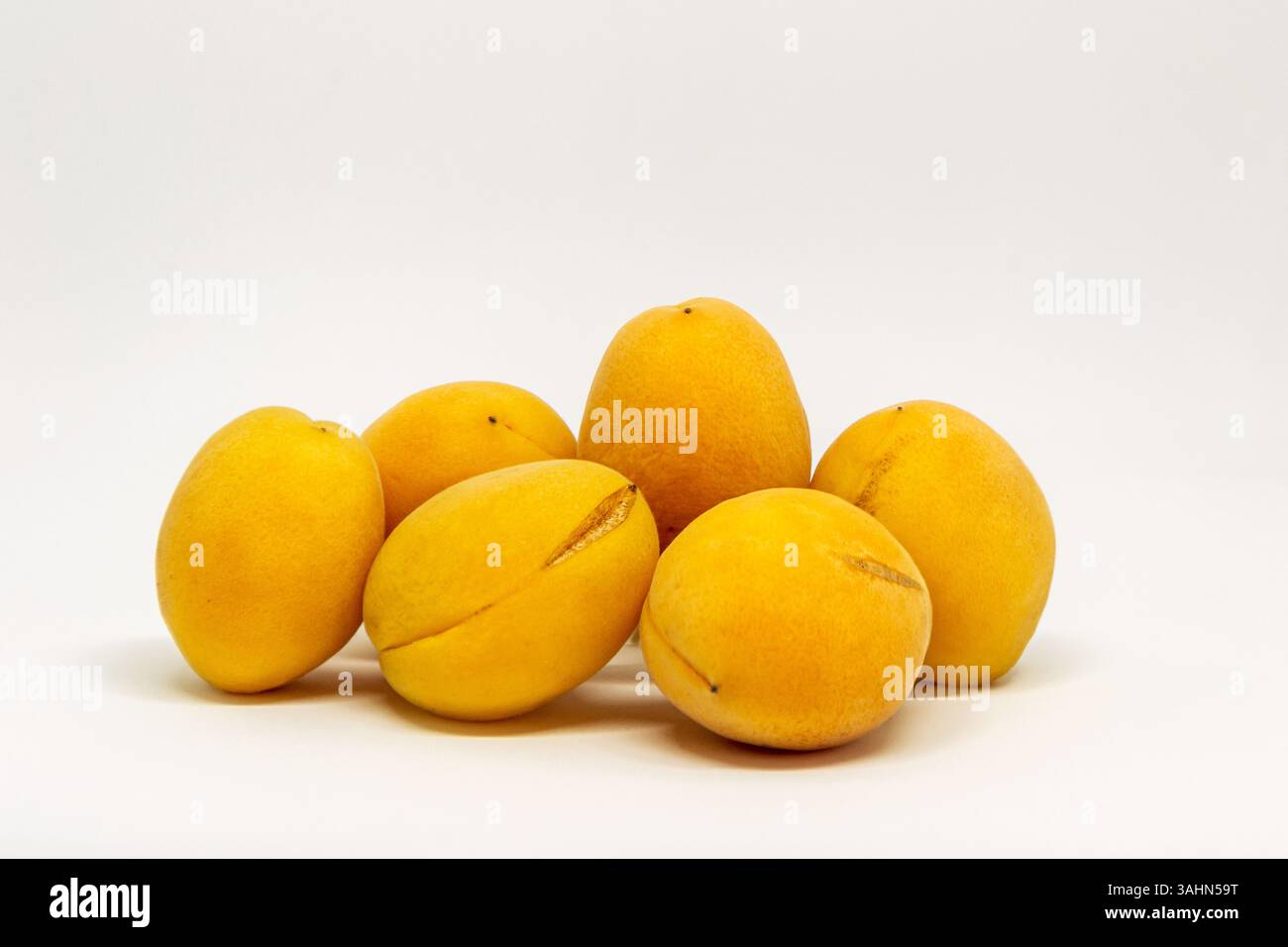 Bunch of yellow peaches are piled on top of each other. The peaches are ...