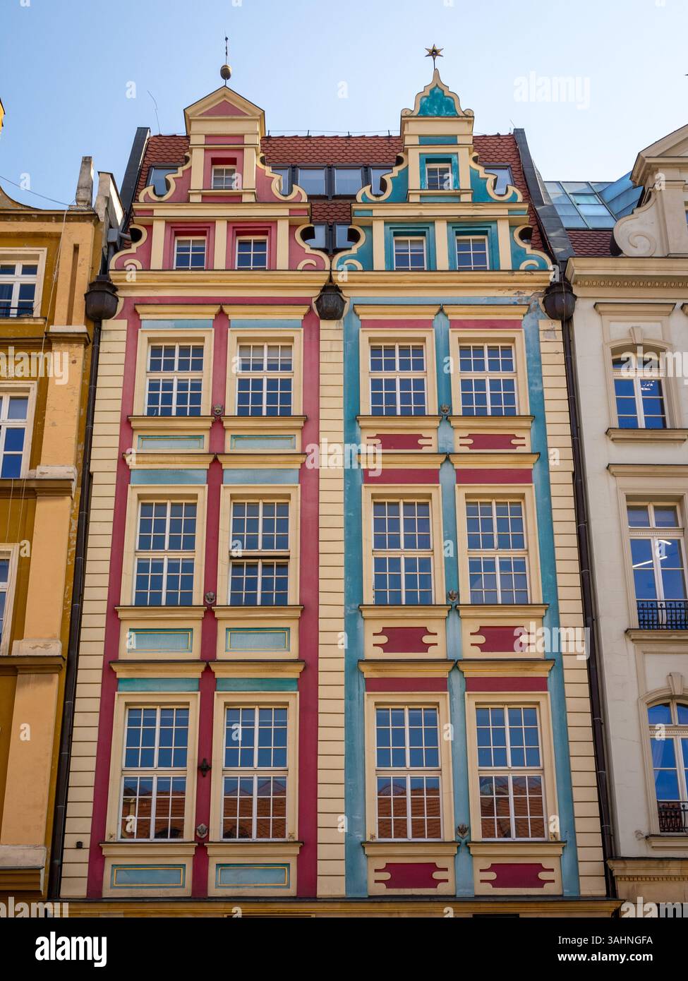 In a picturesque scene, there is a row of vibrant, colorful buildings ...