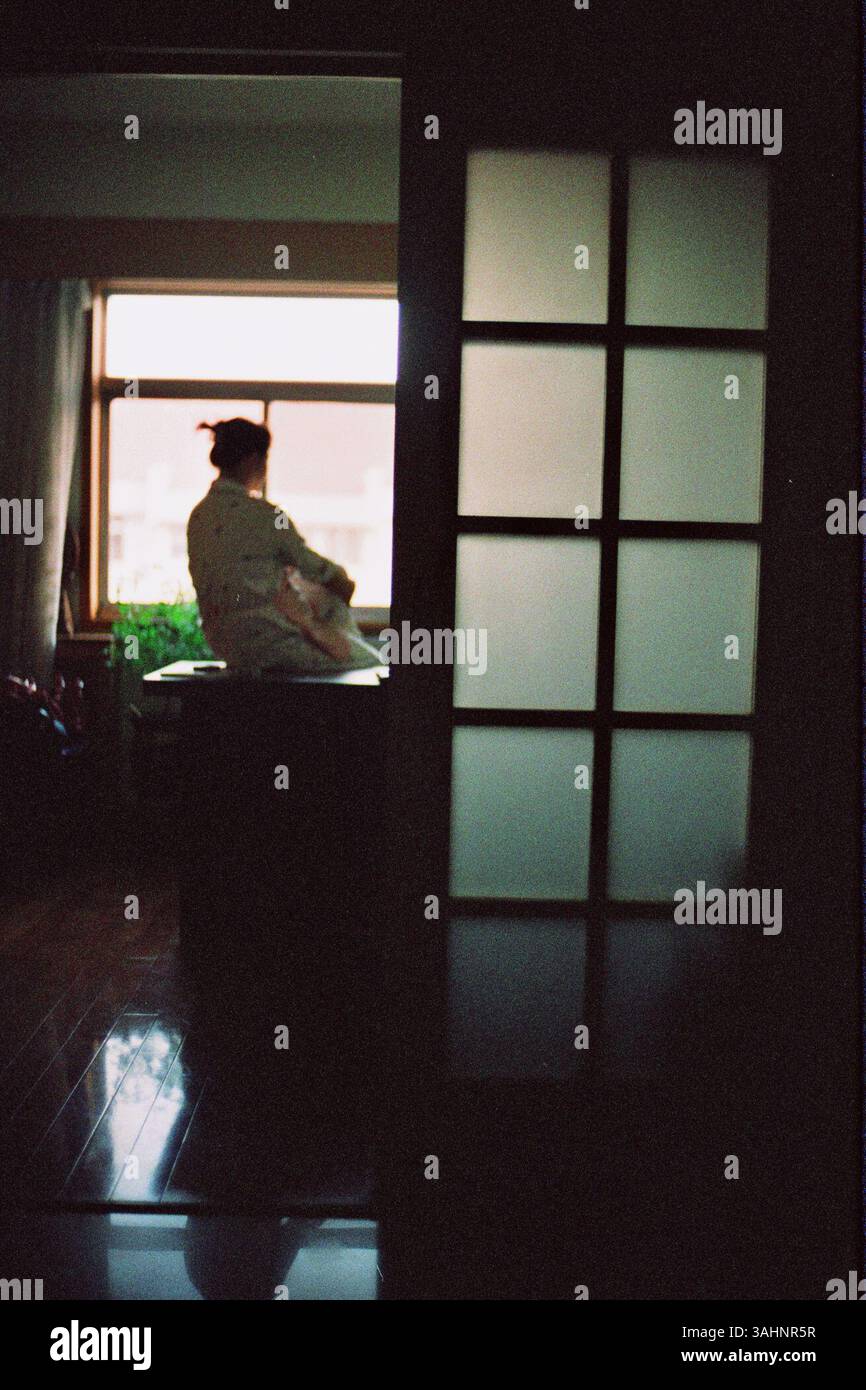 Contemplative Woman in Kimono Sitting by the Window at Dusk – Emotional ...