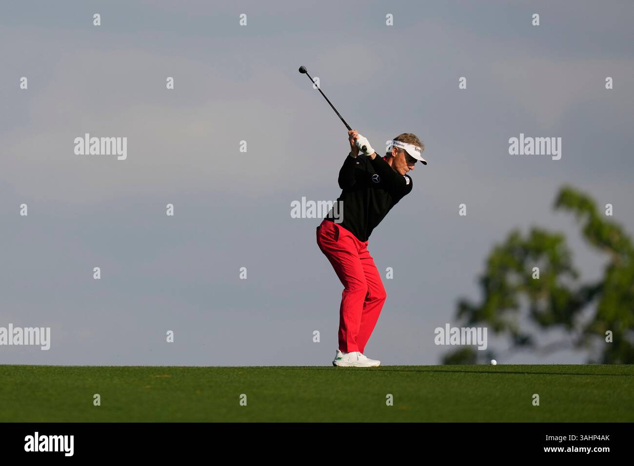 Bernhard Langer, of Germany, hits from the fairway on the second hole ...
