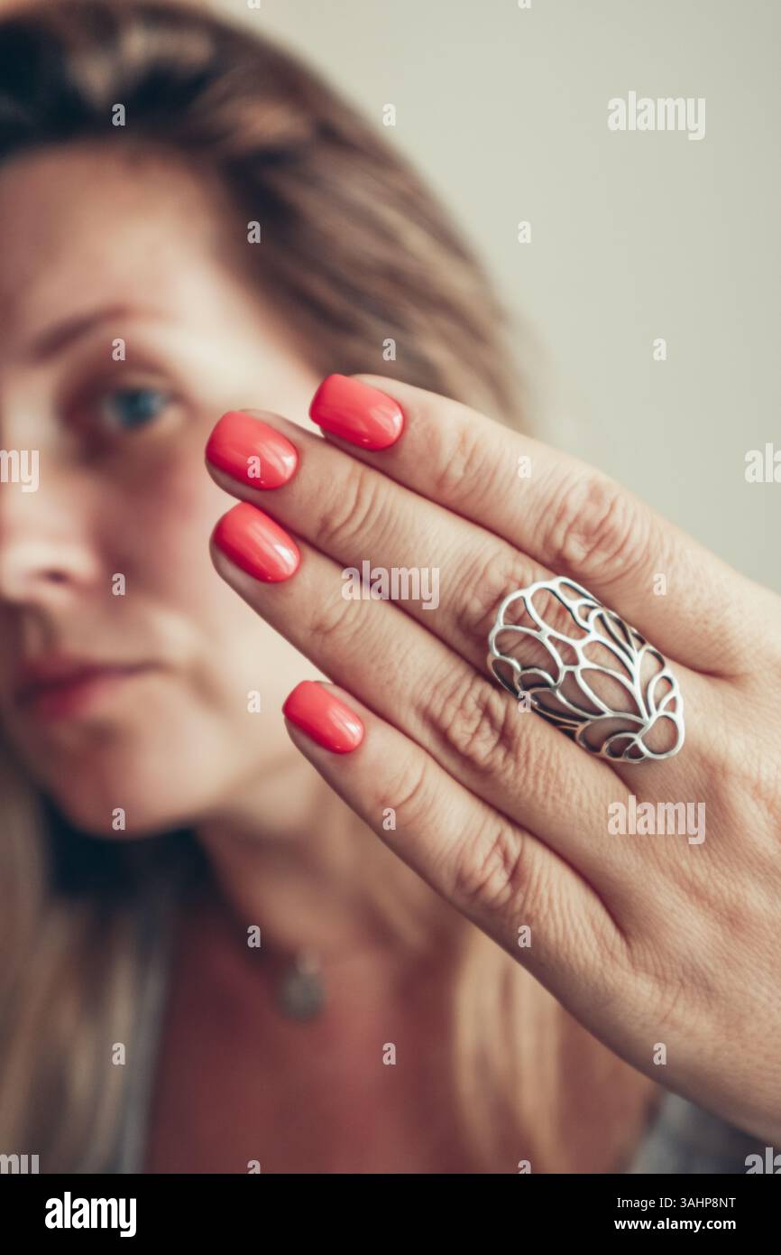 Beautiful mid age woman showing red shellac manicure on nails Stock ...