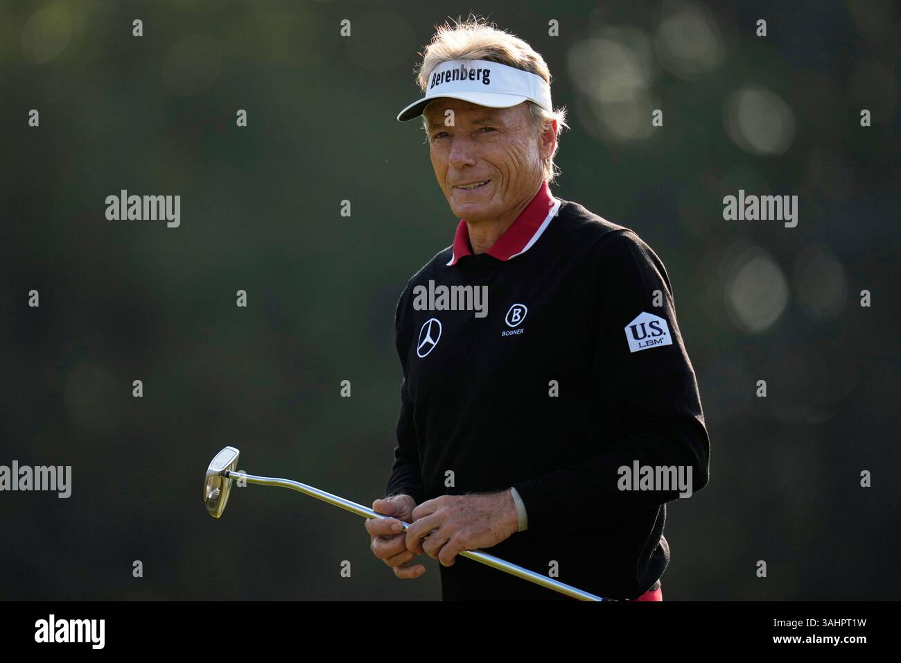 Bernhard Langer, of Germany, walks to the green on the first hole ...