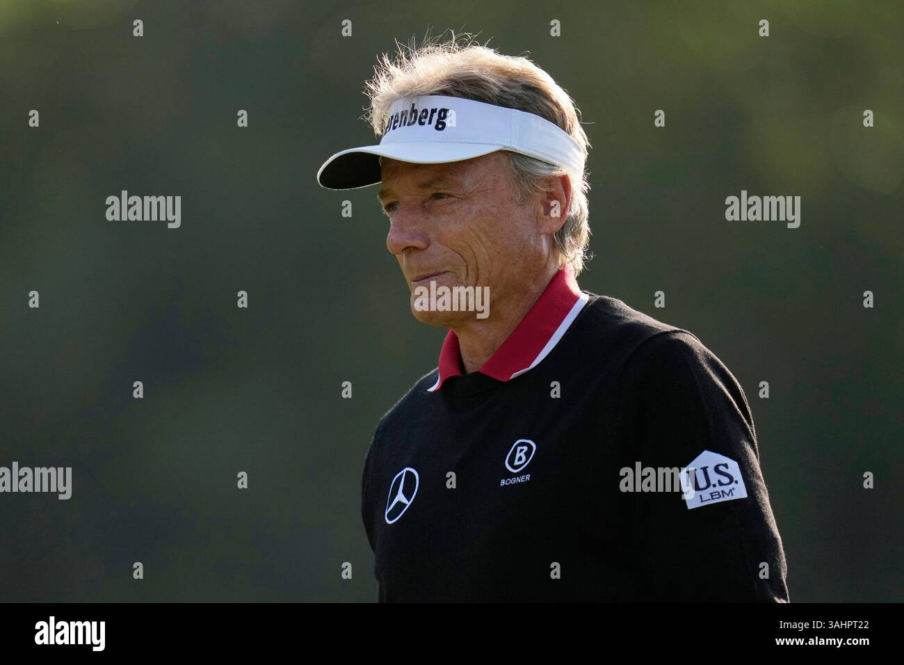 Bernhard Langer, of Germany, walks to the green on the first hole ...
