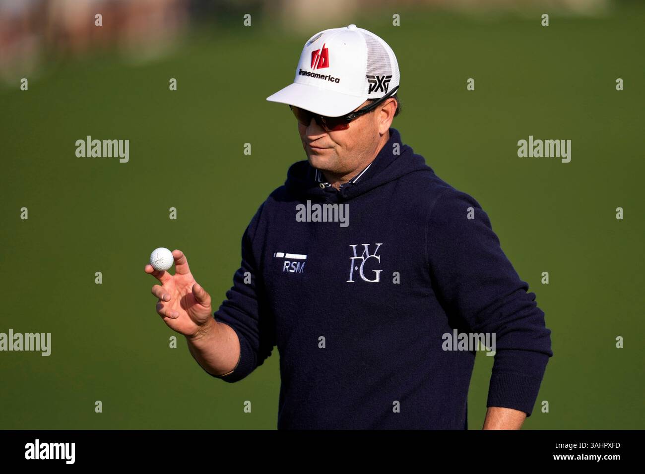 Zach Johnson waves after making a putt on the second hole during the ...