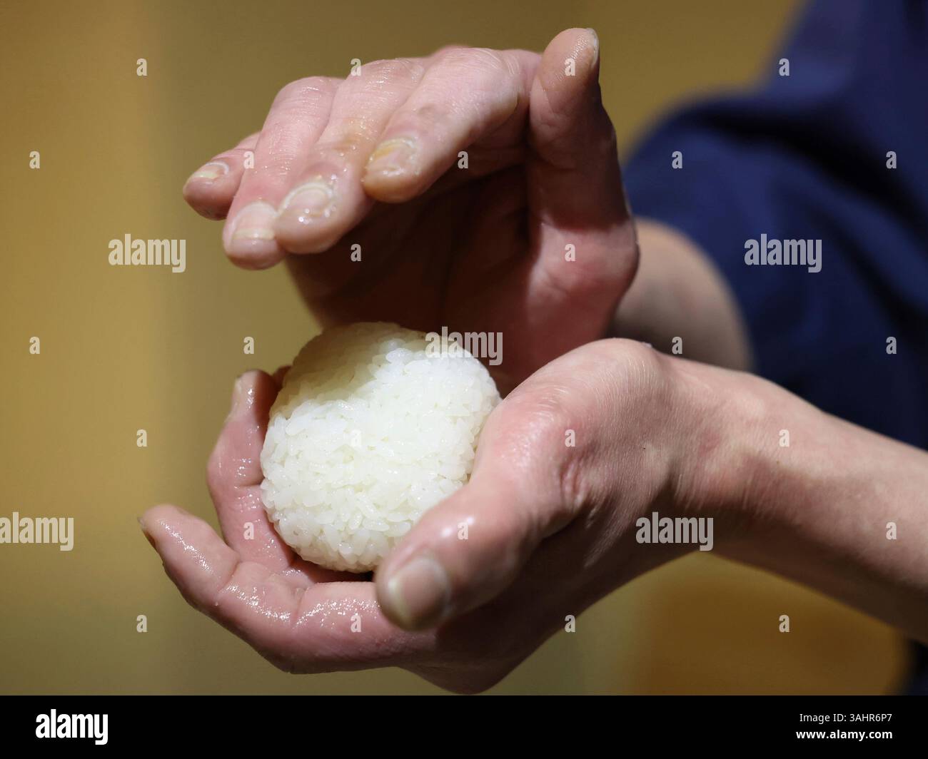 A photo shows how to make an onigiri (rice ball) in Bunkyo Ward, Tokyo ...