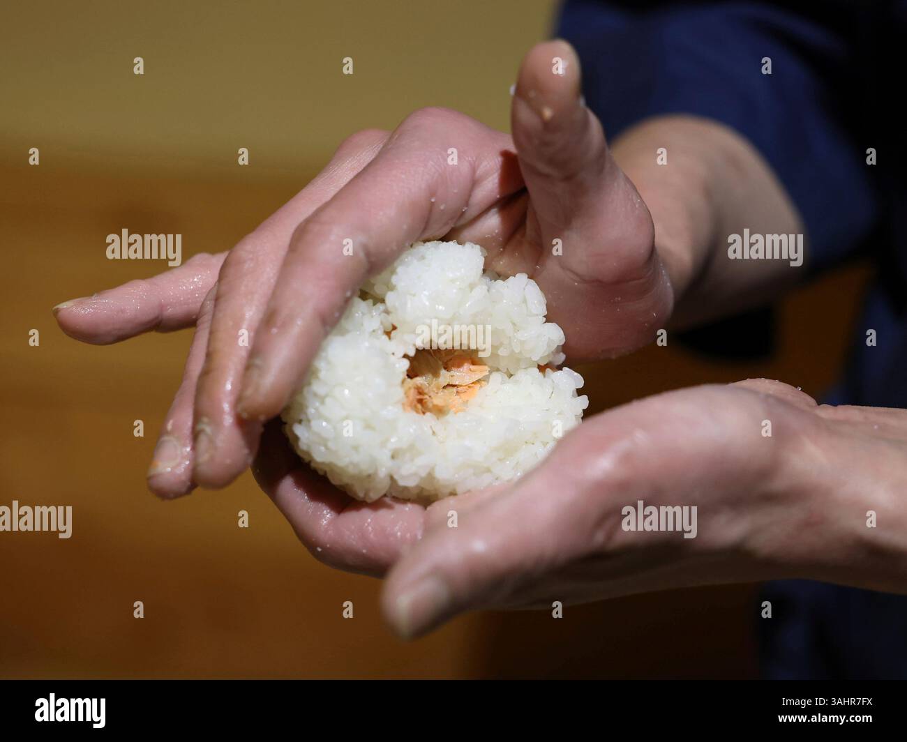 A photo shows how to make an onigiri (rice ball) in Bunkyo Ward, Tokyo ...