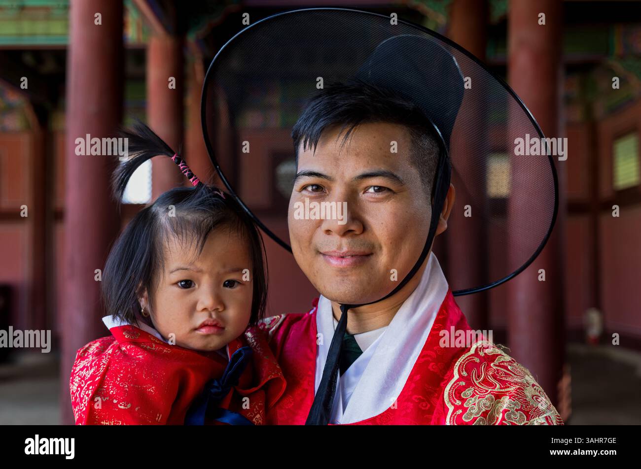 A father and child dressed in traditional Korean Hanbok dress ...