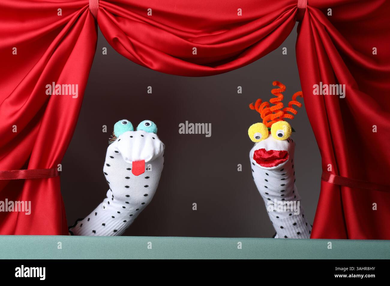 Creative puppet show on stage with red curtains Stock Photo - Alamy