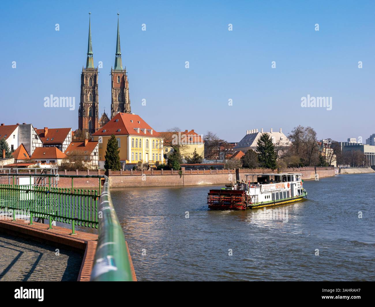 A boat floats gracefully on a serene river with a city skyline in ...
